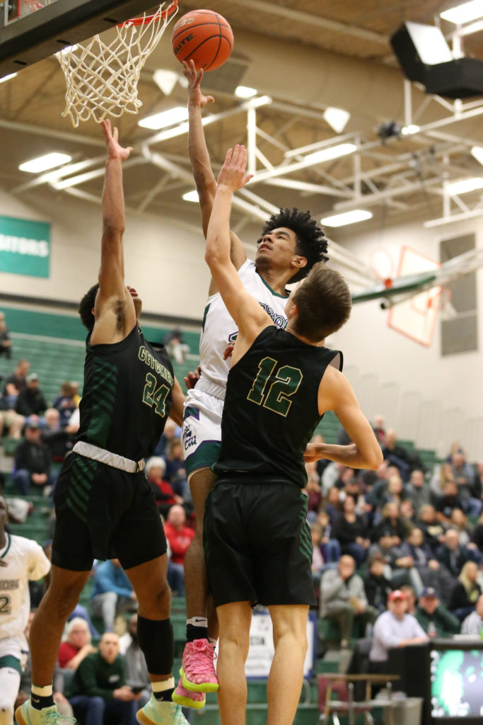 Nikko McNeal drives to the hoop between Getchell’s Malakhi Knight (left ...