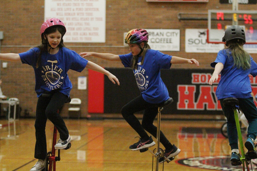 Heck on wheels: Unicycle riders entertain crowd at basketball half-time ...
