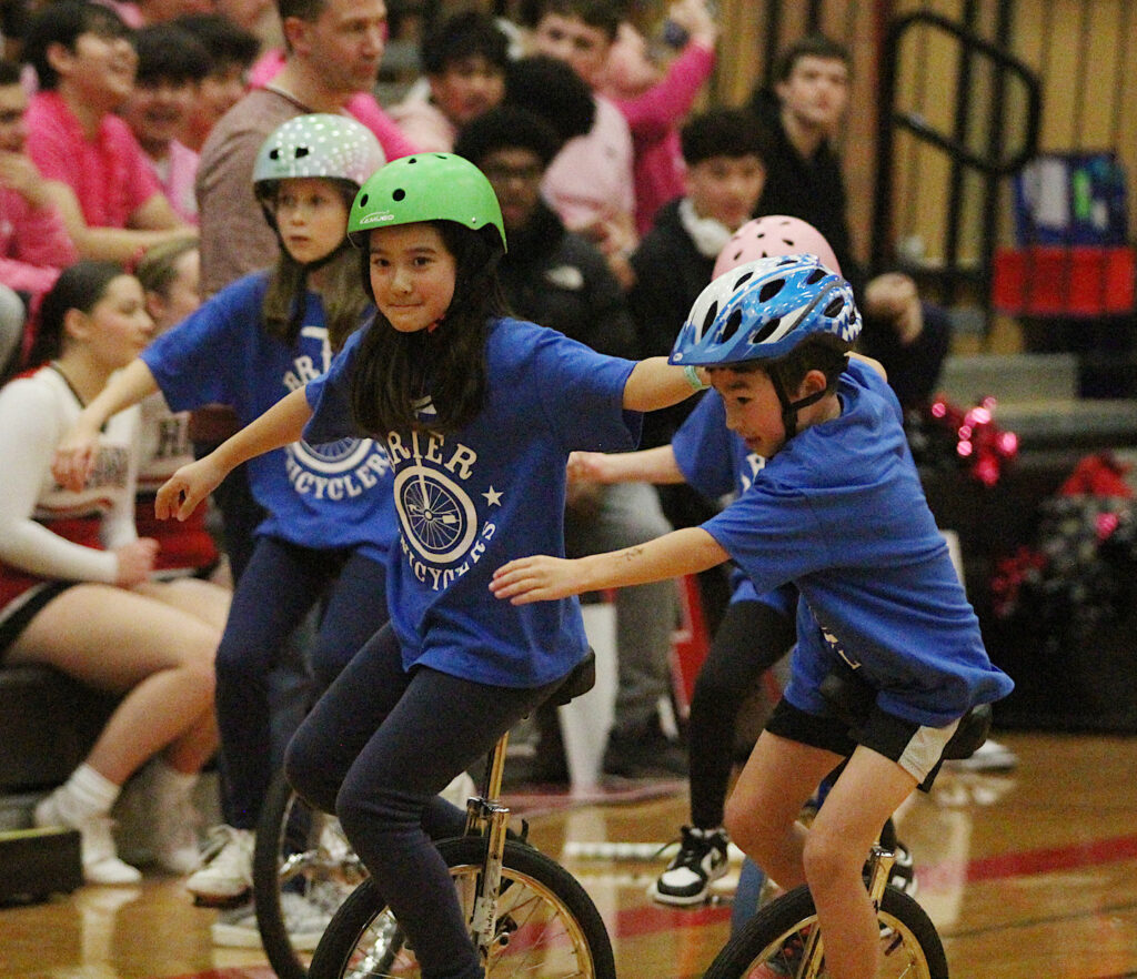 Heck on wheels: Unicycle riders entertain crowd at basketball half-time ...