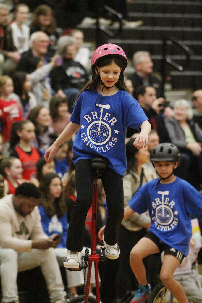 Heck on wheels: Unicycle riders entertain crowd at basketball half-time ...
