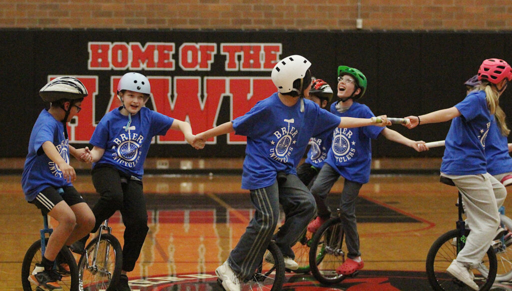 Heck on wheels: Unicycle riders entertain crowd at basketball half-time ...